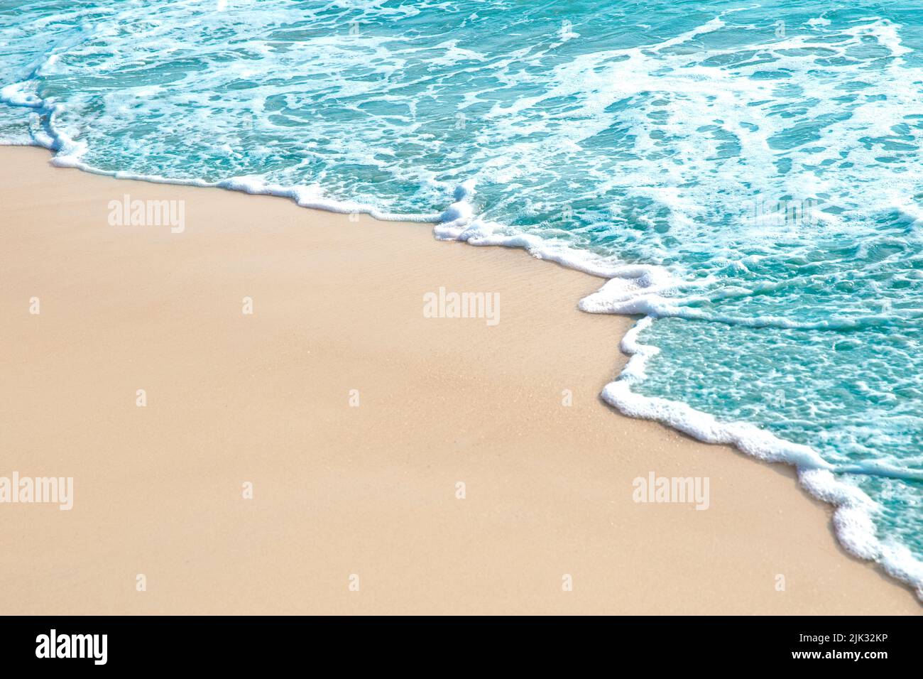 Soft wave and sea bubble of blue sea on sandy beach Stock Photo - Alamy
