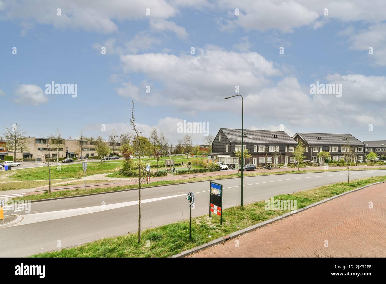 Front view of old brick buildings and cars with bicycles from small ...