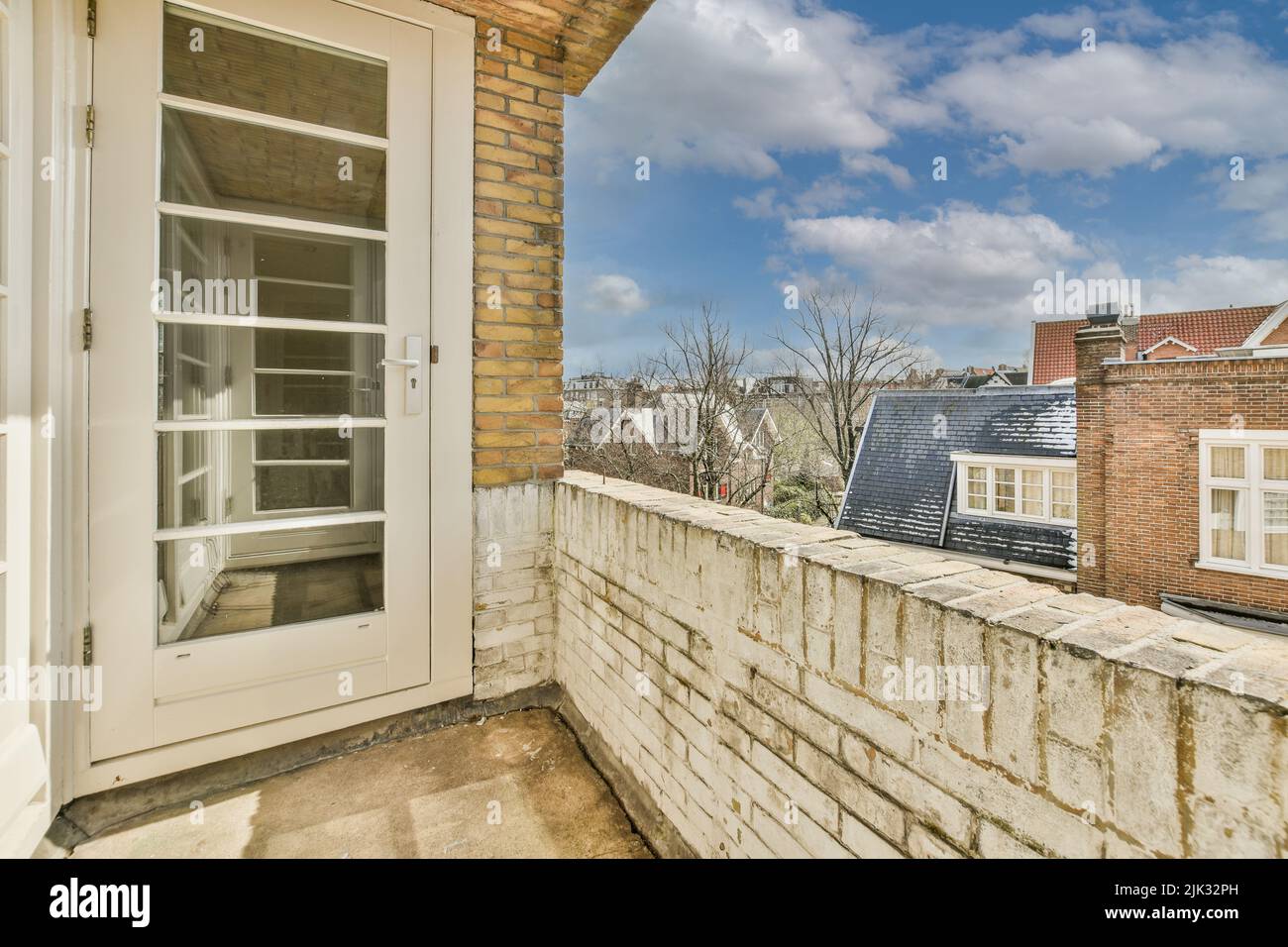 Narrow brick balcony with metal railings and door Stock Photo - Alamy