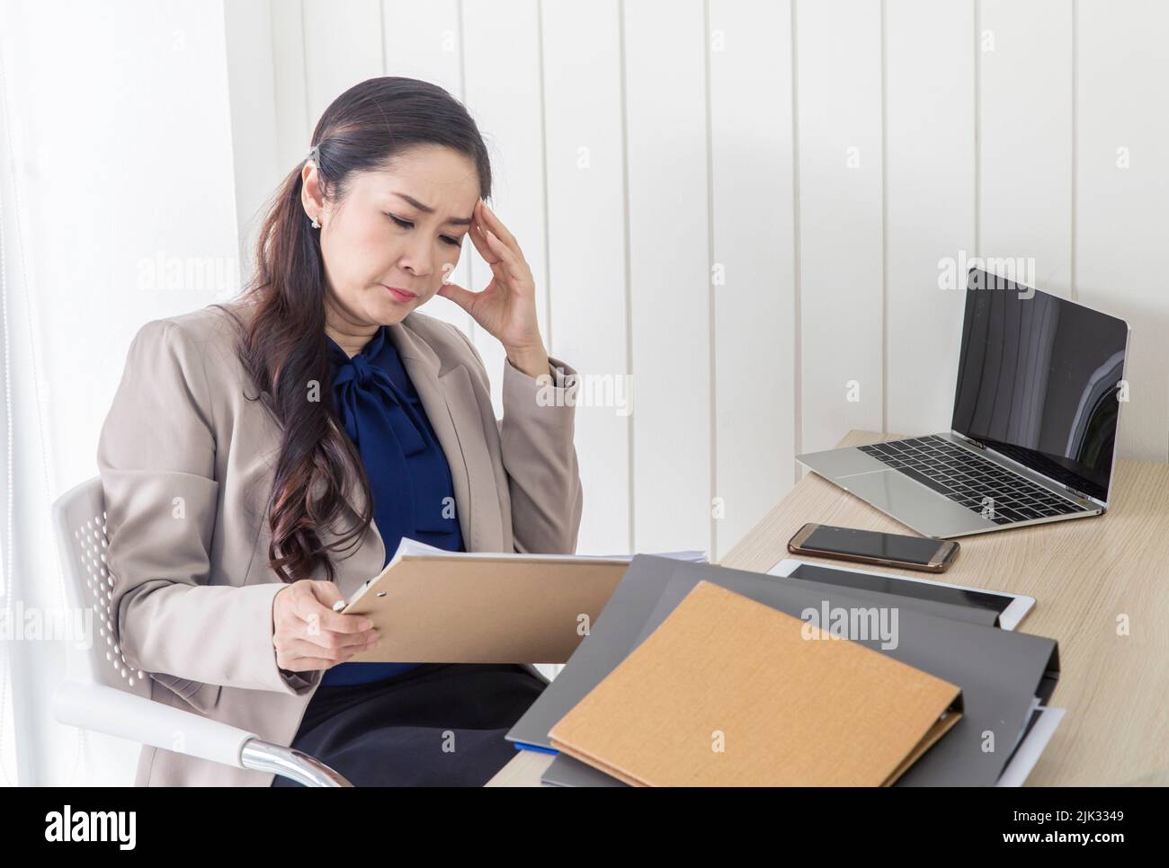 Asian business woman with headache at office , Tired accountant with ...