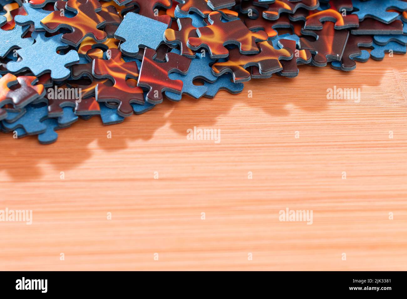 Colorful Peaces of a Mixed Jigsaw Puzzle Lie on the Wooden Table ...