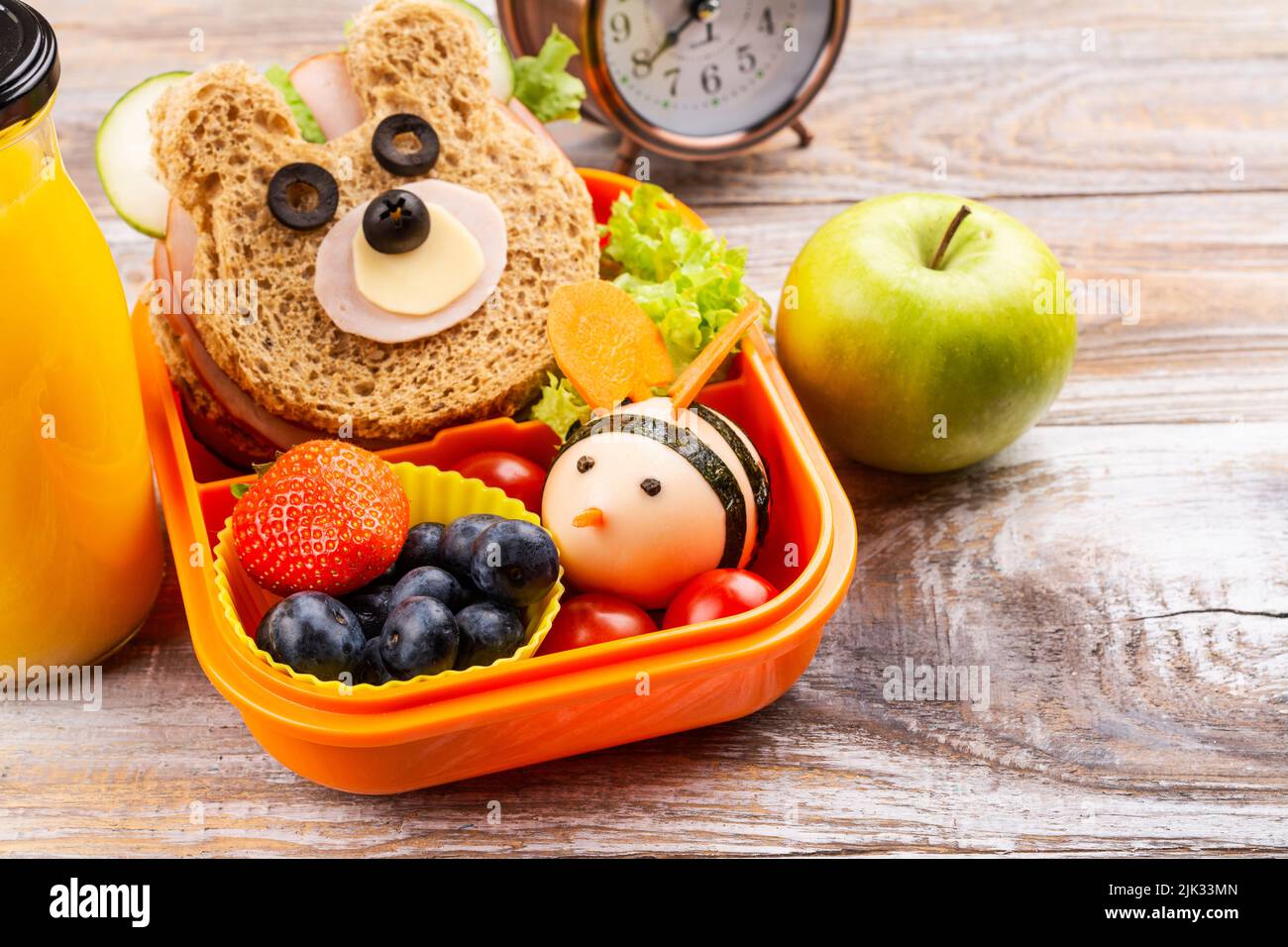 Kids lunch box with funny bear sandwich and boiled egg bee, apple ...