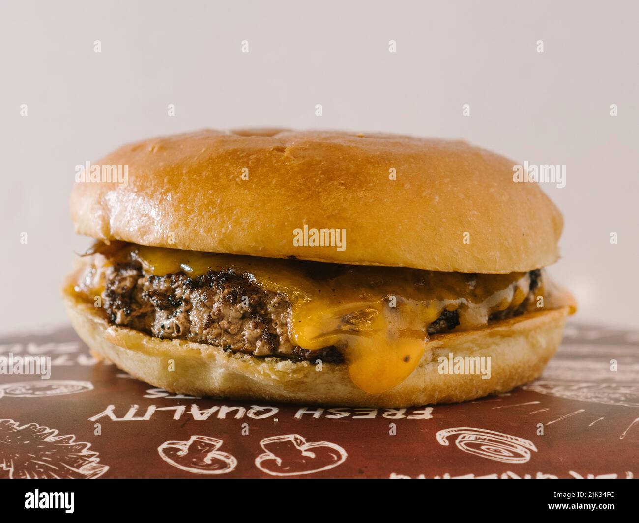 Close up view of Single cheese burger with caramalised onions Stock ...