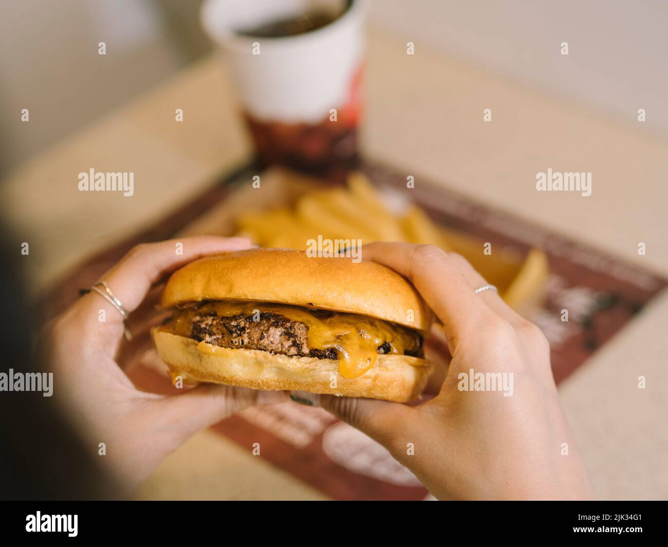 Lady Pov Holding Cheese Burger With Fries And Soda Stock Photo Alamy