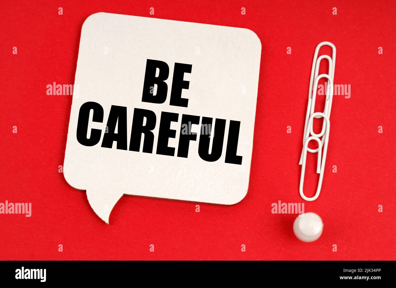 Business concept. On a red background, paper clips are an exclamation ...