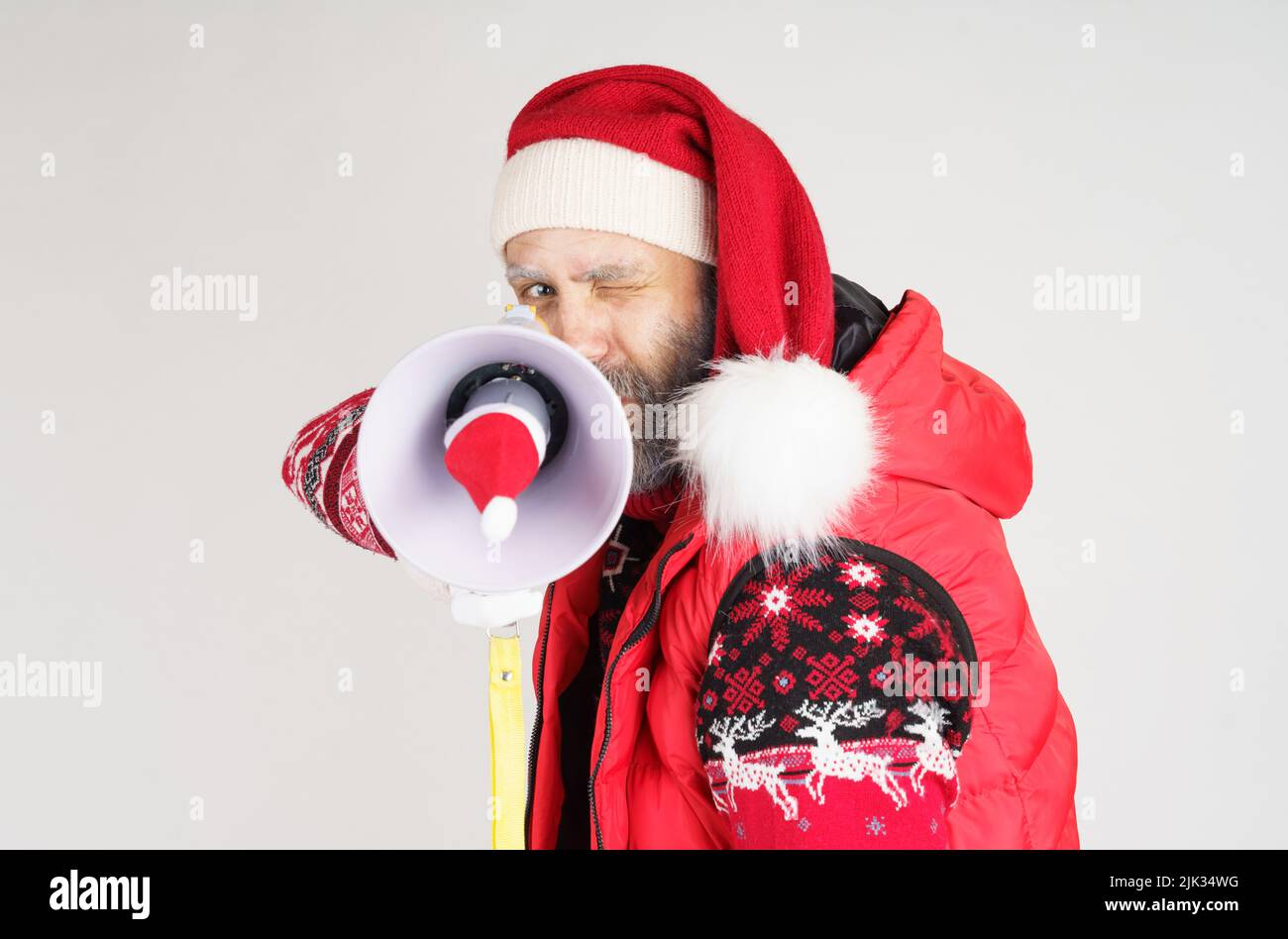 New Year and Christmas concept. Santa Claus holds a loudspeaker in his ...