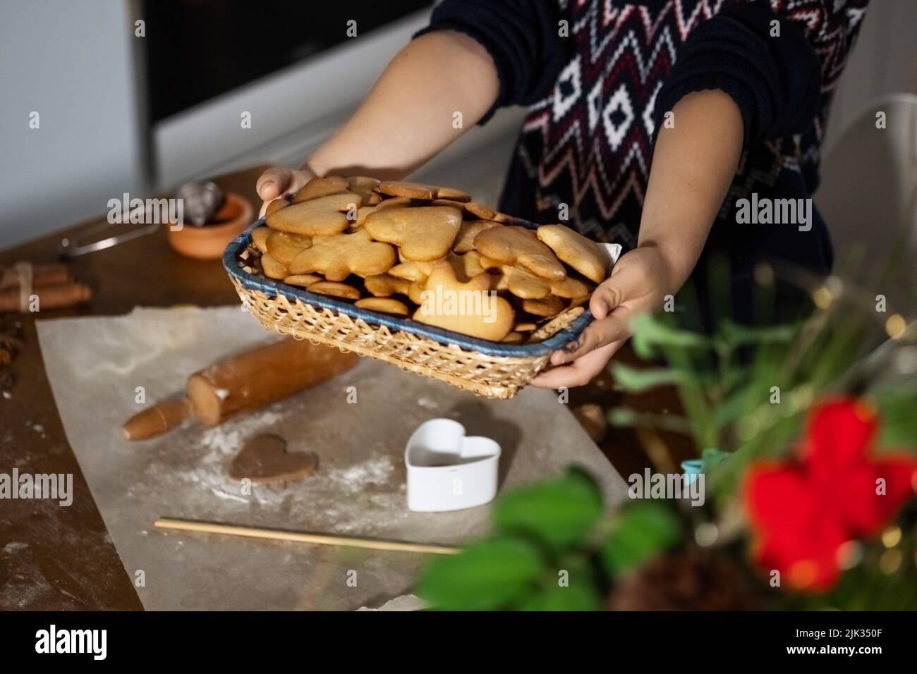 Christmas food concept. Child is holding gingerbread man cookies in ...
