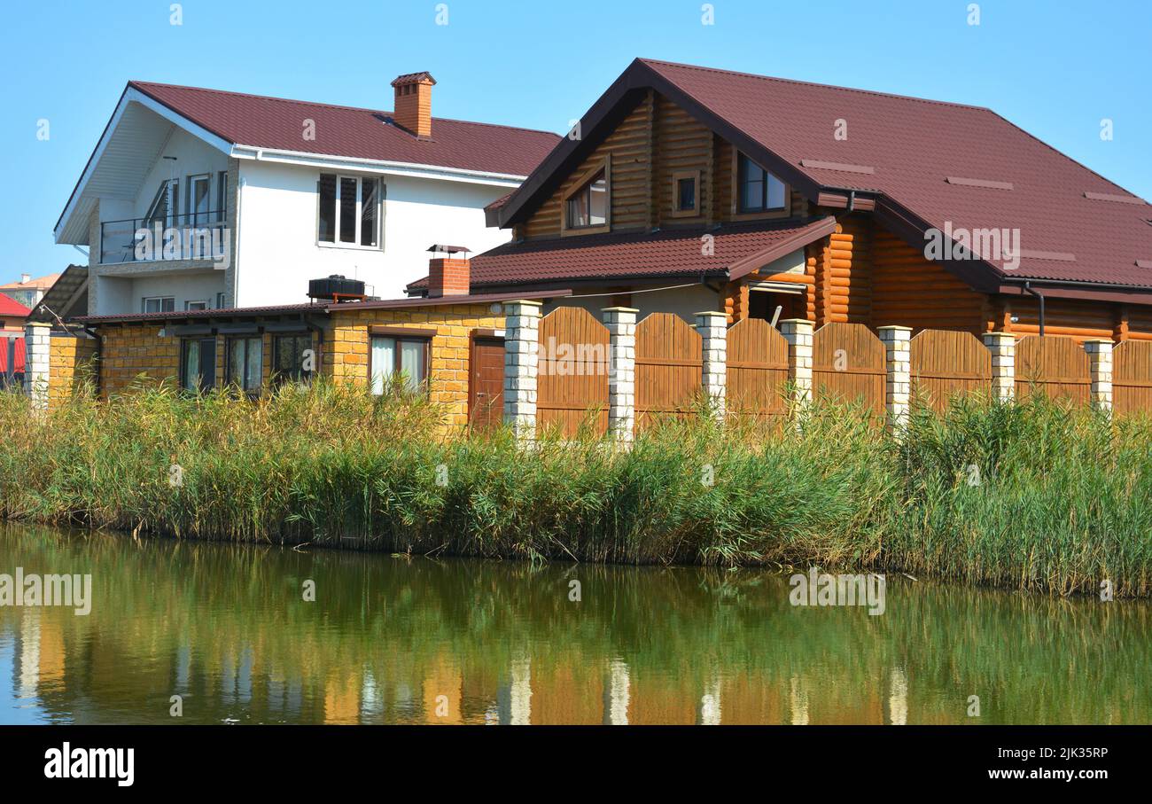 Riverbank cottages. Attractive wooden and brick cottages built on the ...