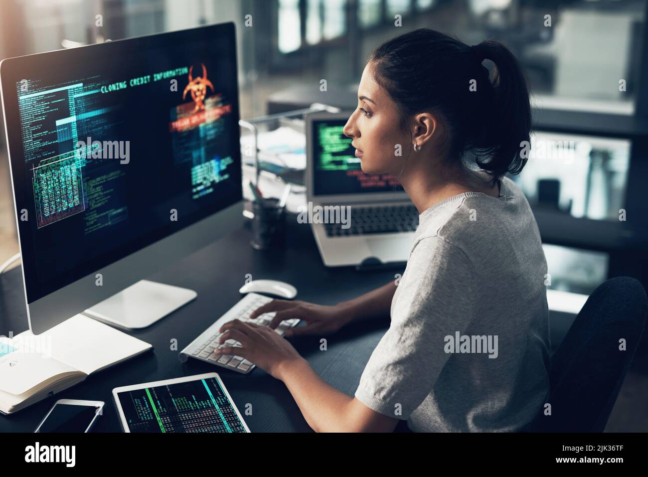 No one blocking this shine. a young woman using a computer in a modern ...