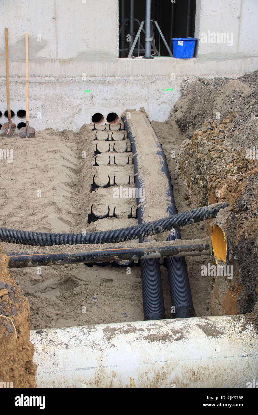 Empty conduits for cables lie in a trench Stock Photo - Alamy