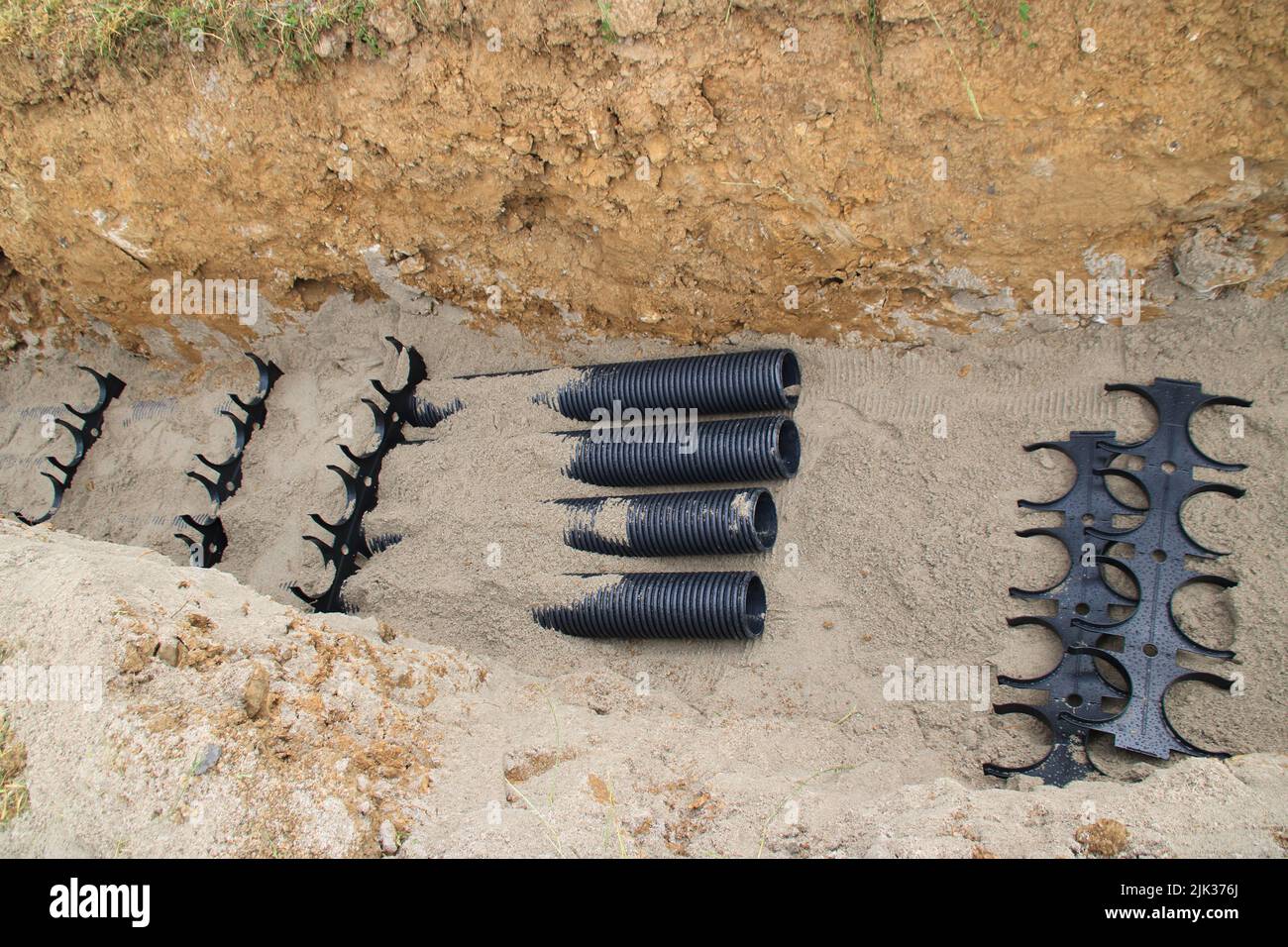Empty conduits for cables lie in a trench Stock Photo - Alamy