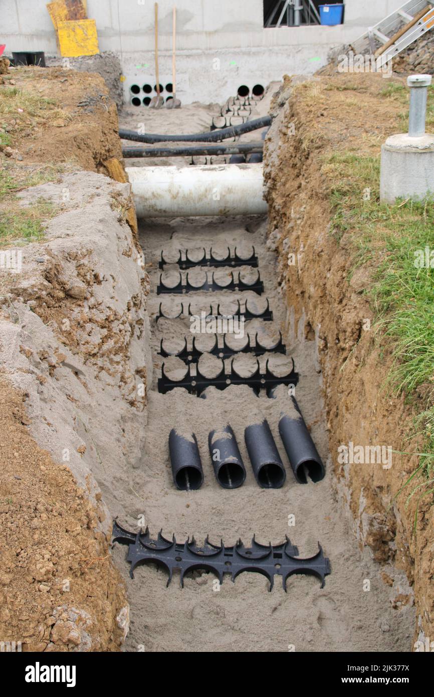 Empty conduits for cables lie in a trench Stock Photo - Alamy