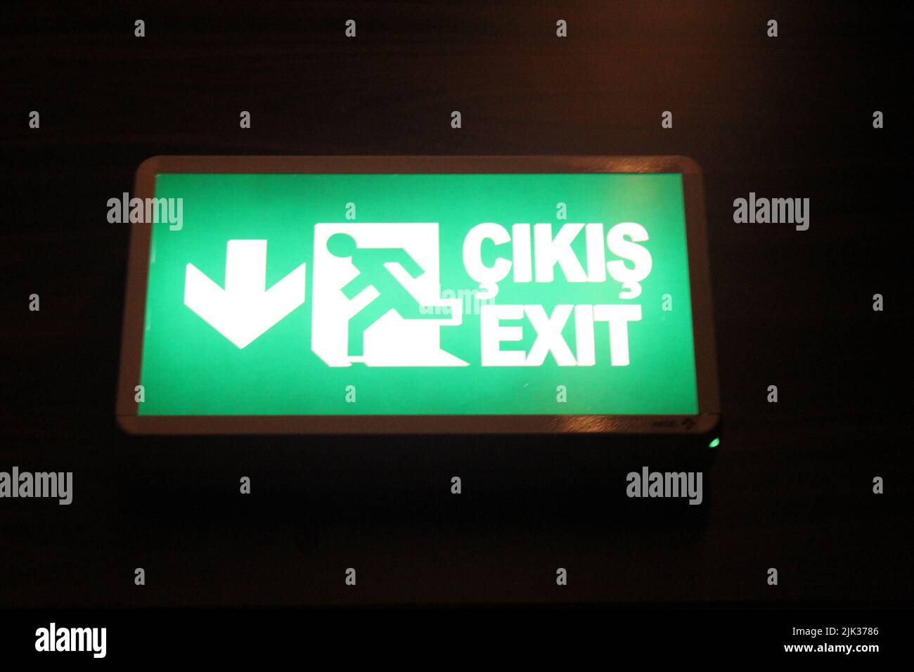 Green light signboard (The Turkish meaning of exit is çıkış). Close-up ...