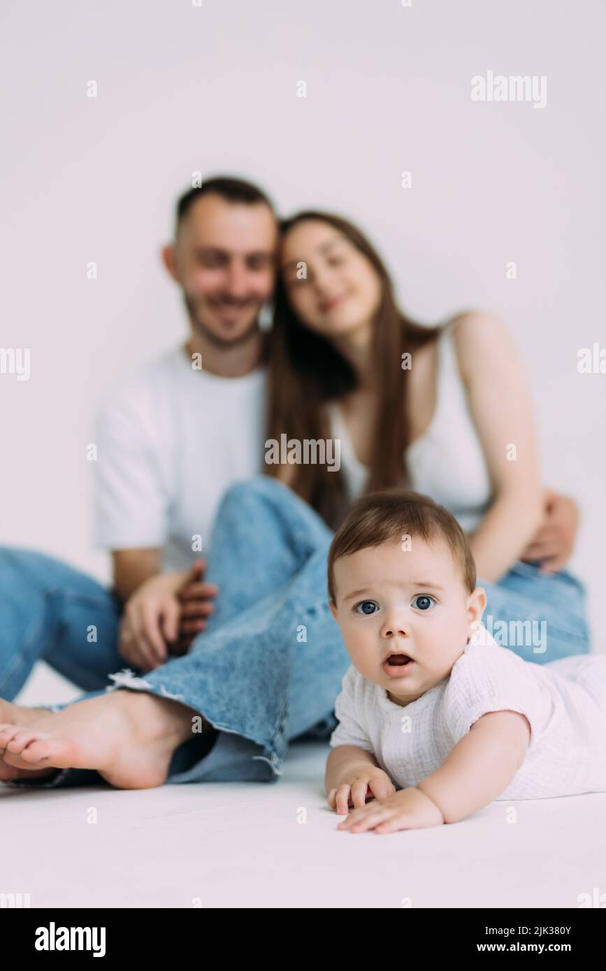 Side view of infant baby toddler in diaper and white bodysuit is ...