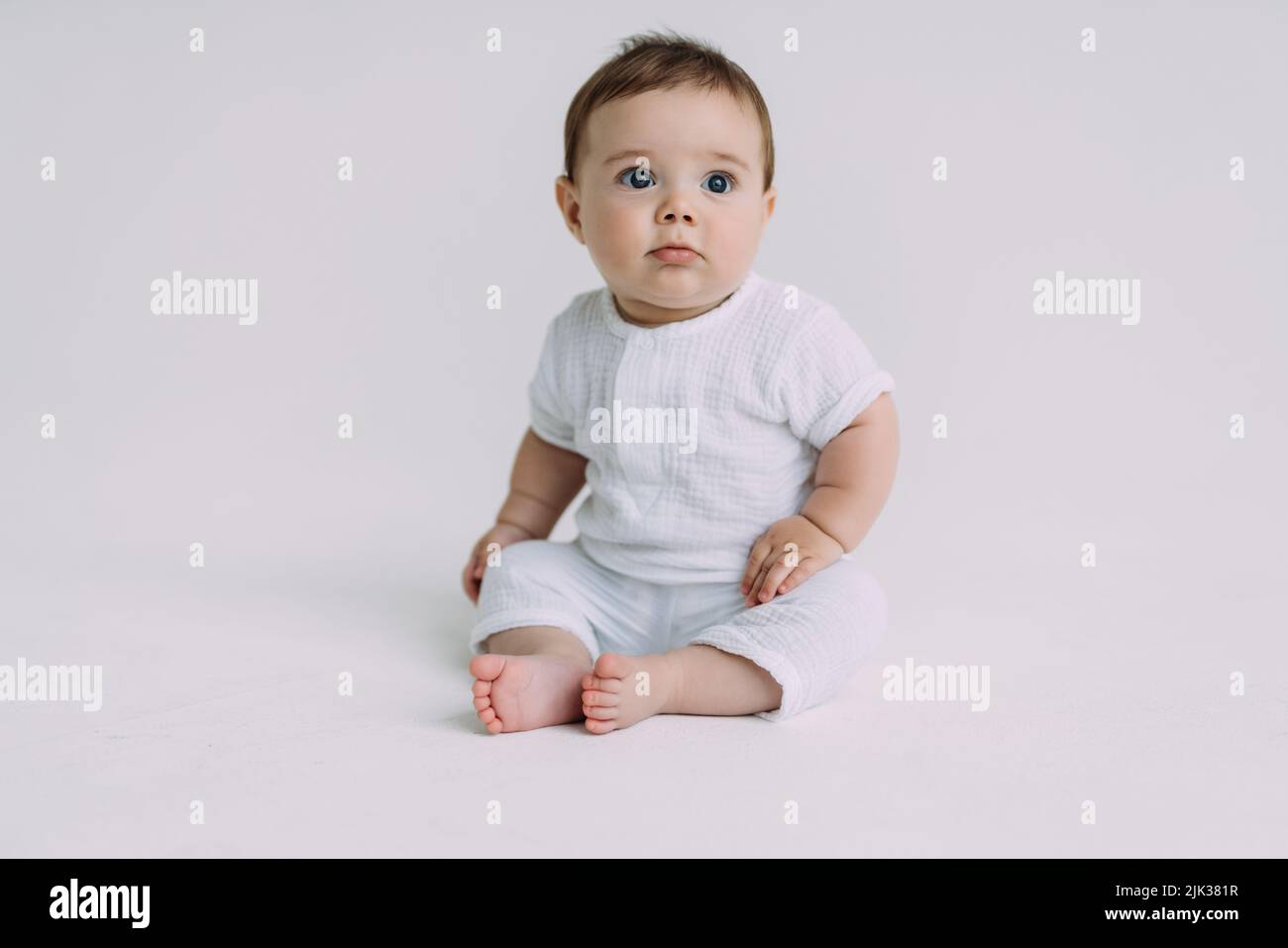 Young parents lying in bed, playing and looking at their cute little ...