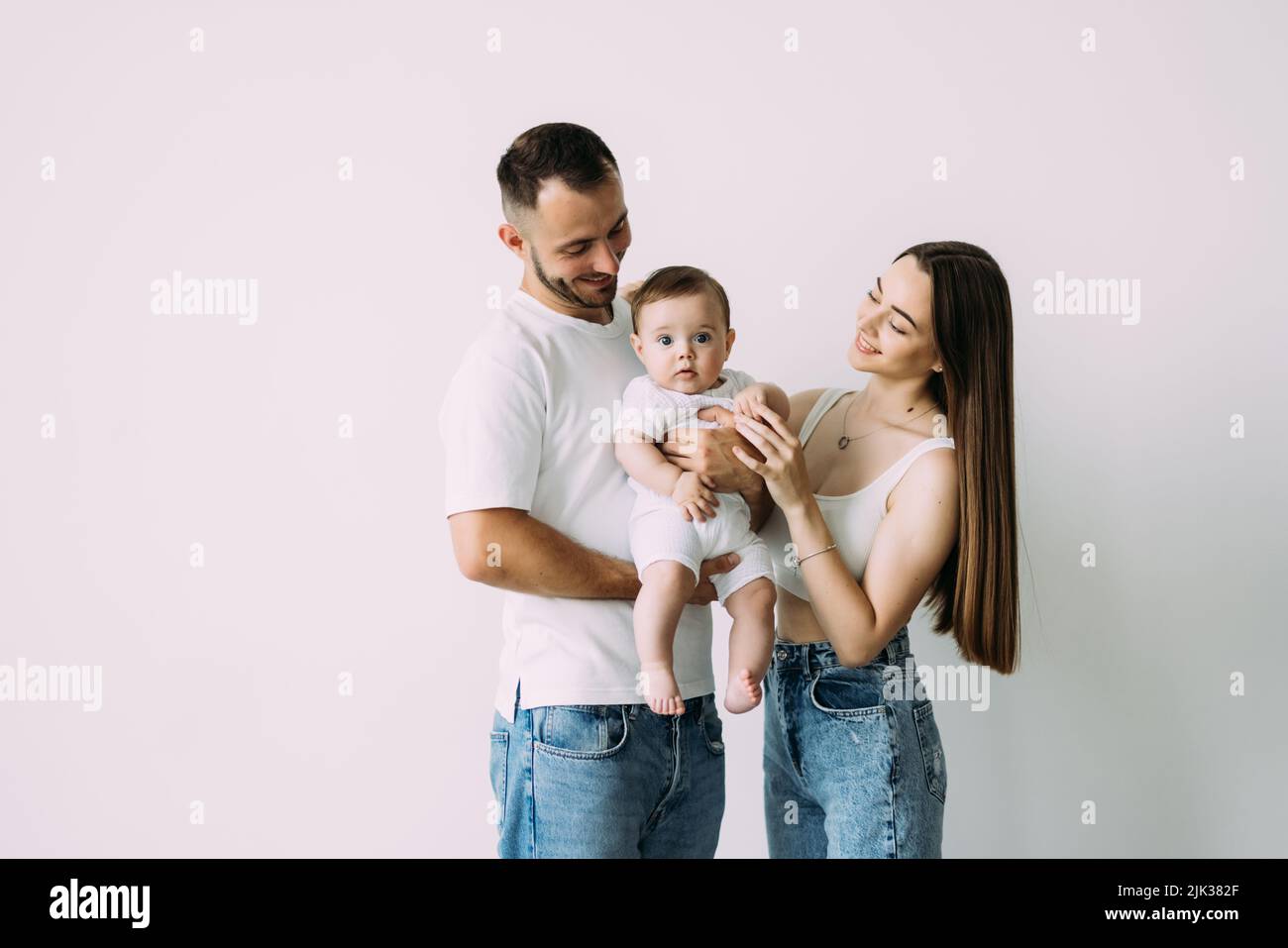Full length portrait of a happy young family with their little son ...