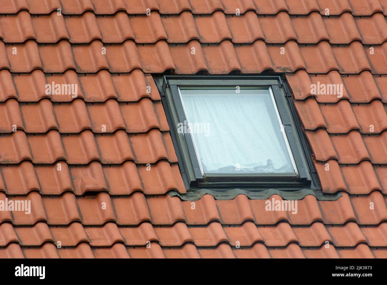Single window in the brown attic roof Stock Photo - Alamy