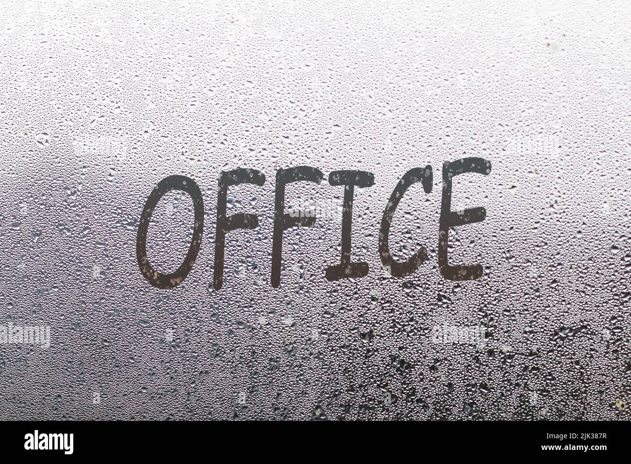 The Word Office Written On Night Wet Window Glass Close Up With Blurred