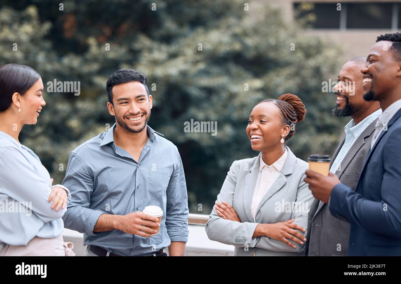 Getting to know my colleagues. a group of businesspeople outside having ...