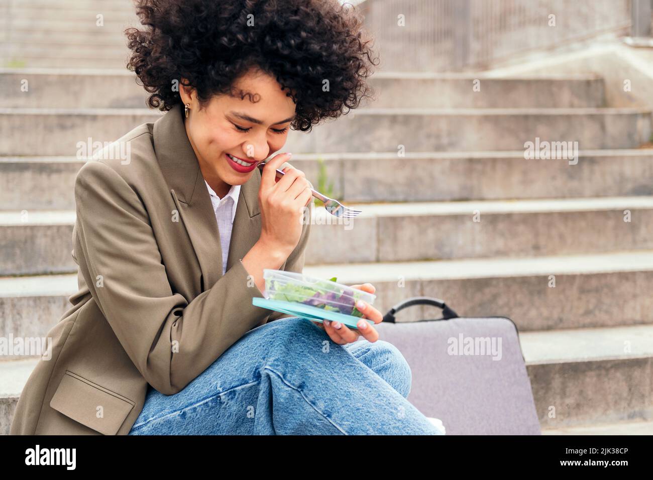 woman laughing and eating during a break from work Stock Photo - Alamy