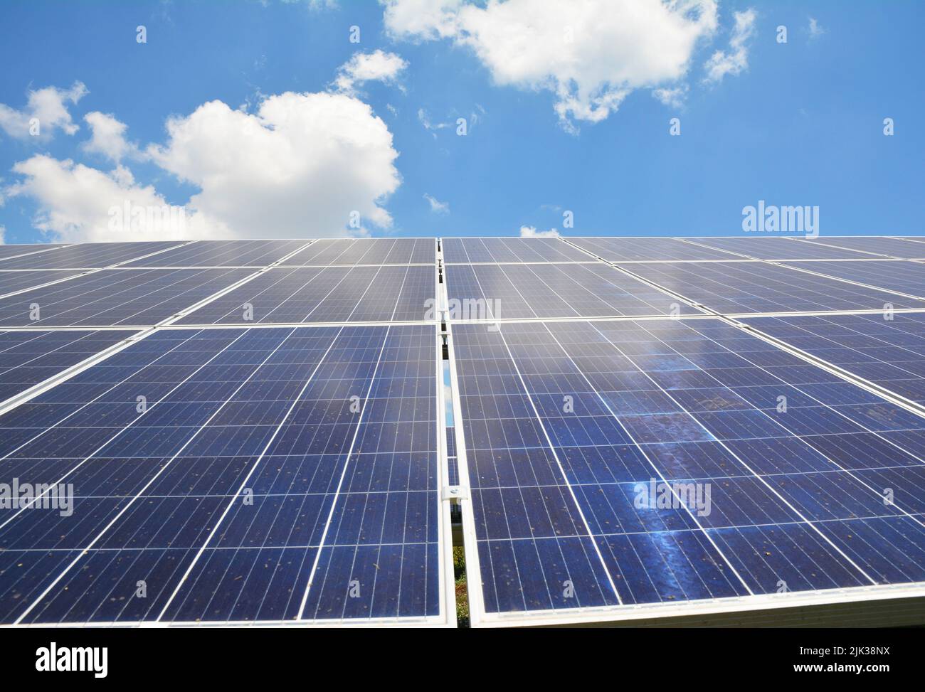 Solar panels with clouds in the background as a concept of renewable ...