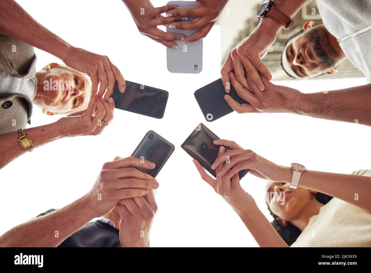 Everyone has a connection to make. Low angle shot of a group of ...