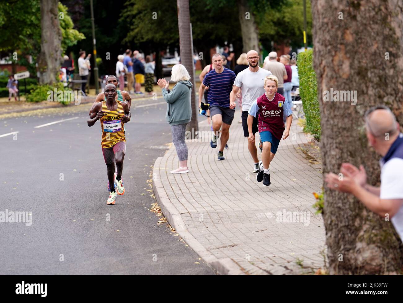 Uganda’s Victor Kiplangat and Tanzania's Alphonce Felix Simbu form a ...