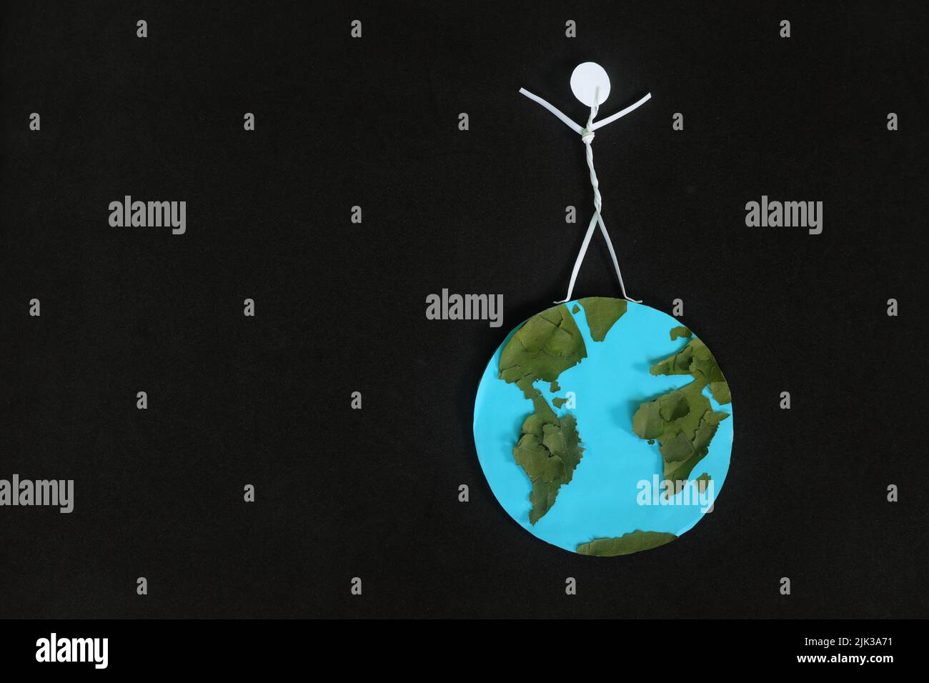 Human stick figure standing on top of planet earth in dark black ...