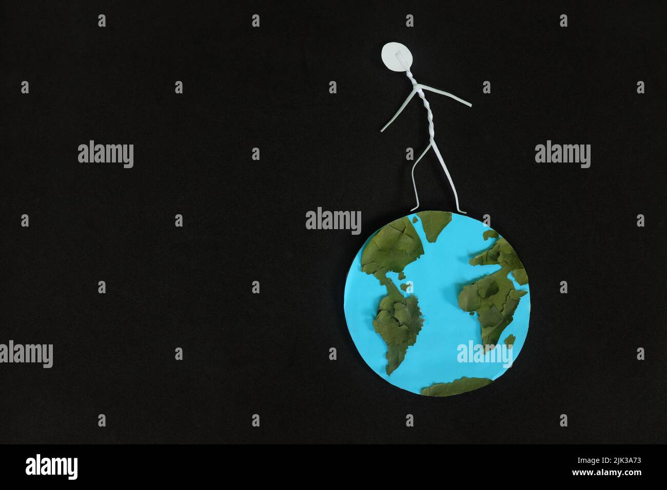Human stick figure walking or running on top of planet earth in dark ...