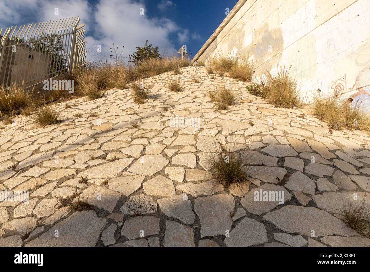 The bridge support lined with stones, overgrown with grass. Texture for ...