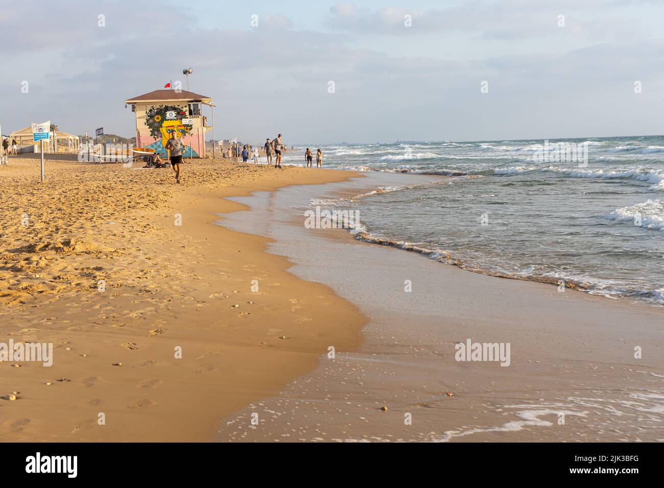 Haifa, Israel - 20 July 2022, Dado beach. People run along the sea ...