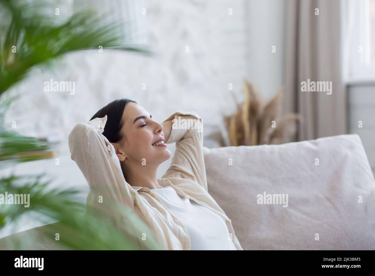 Beautiful brunette woman resting with closed eyes during the day ...