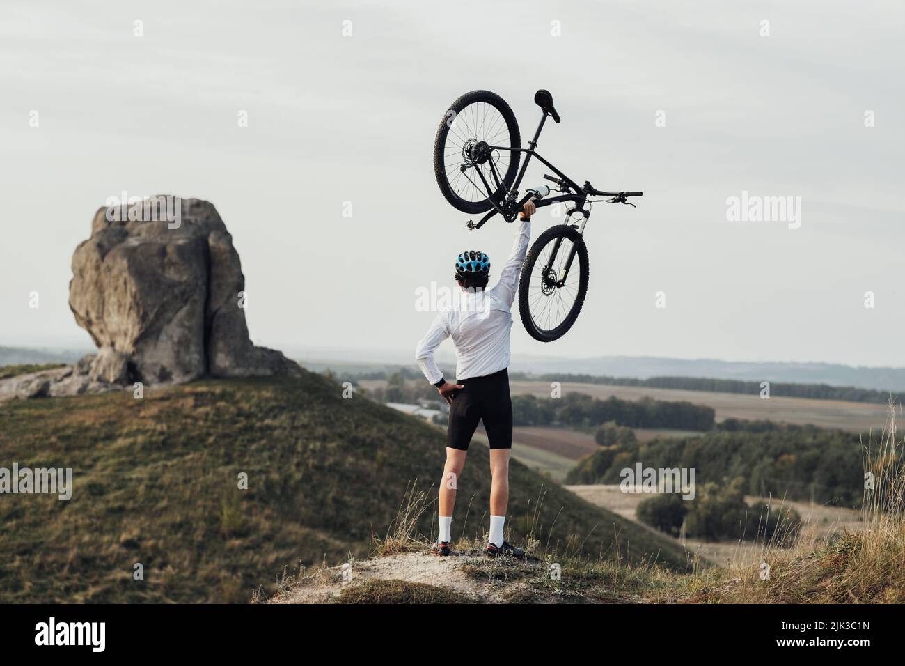 Professional Male Cyclist in Helmet Raising Hand with Bicycle while ...