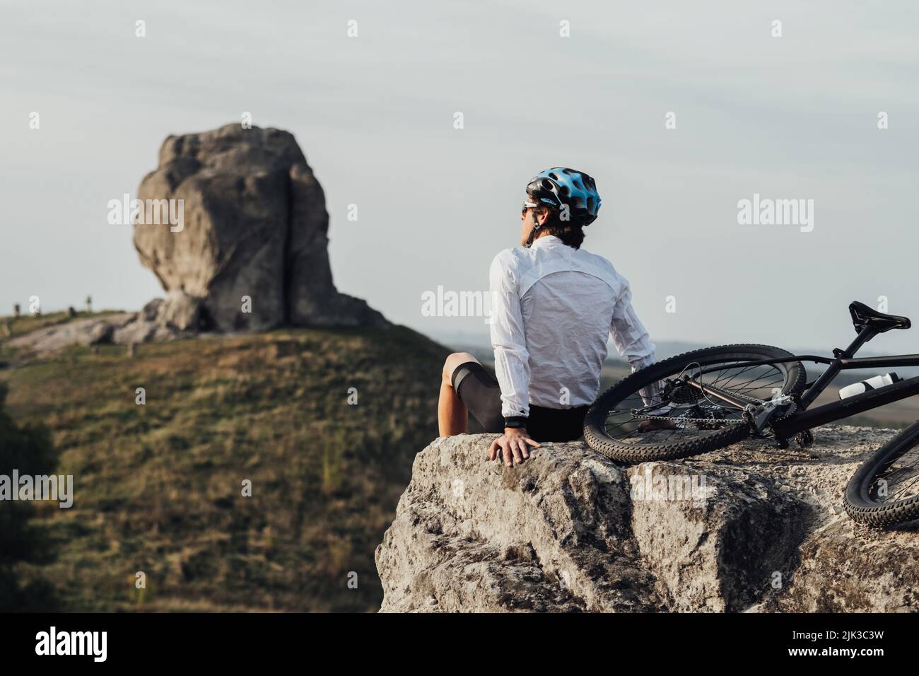 Equipped Professional Male Cyclist Sitting with Mountain Bike on Edge ...