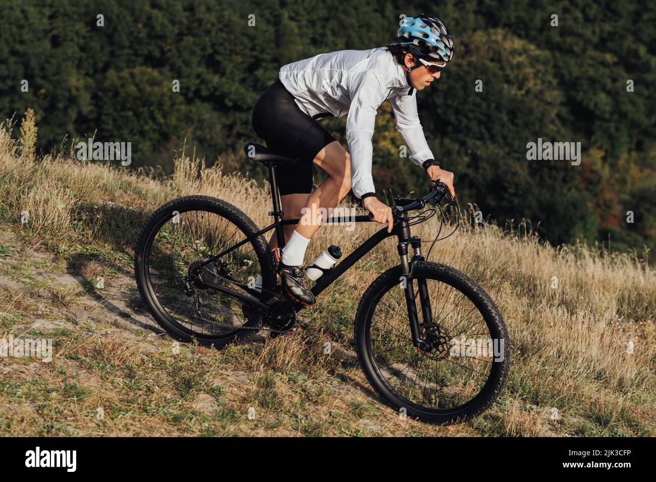 Equipped Professional Cyclist Descends a Slope on His Mountain Bike ...
