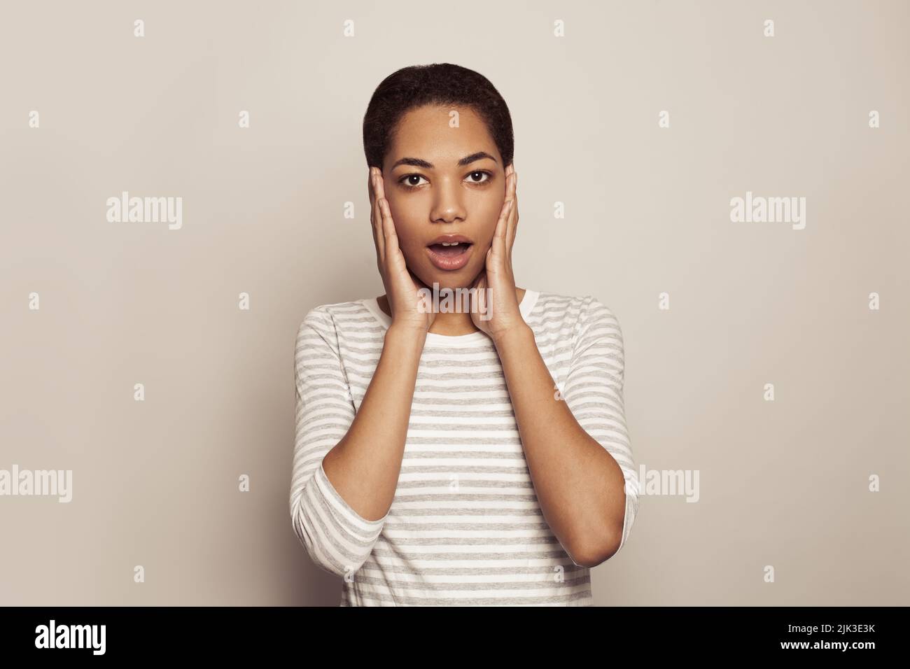 Happy surprised woman on white background Stock Photo - Alamy