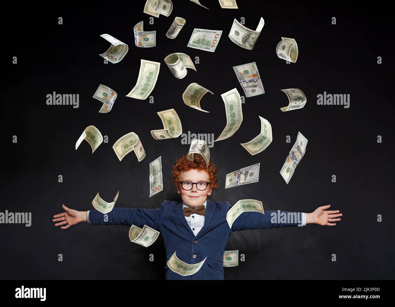 Child little boy under us dollar money rain on blackboard background ...