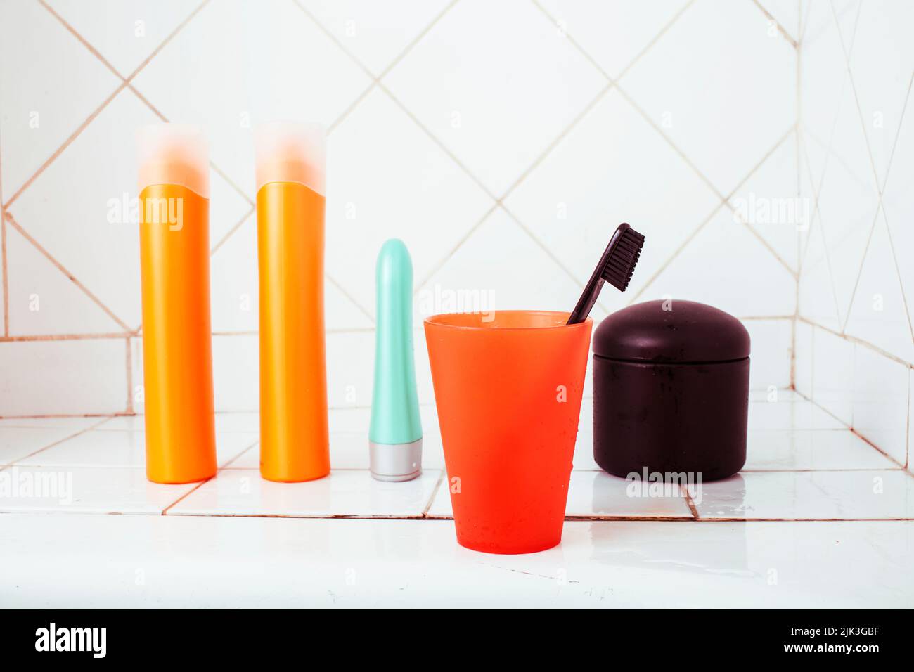 usual stuff in bathroom, shampoo, accessories, black stylish toothbrush ...