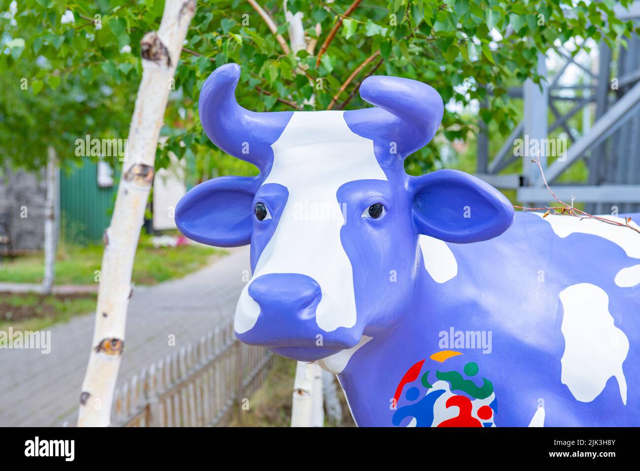one multi-colored cow stands on the lawn Stock Photo - Alamy