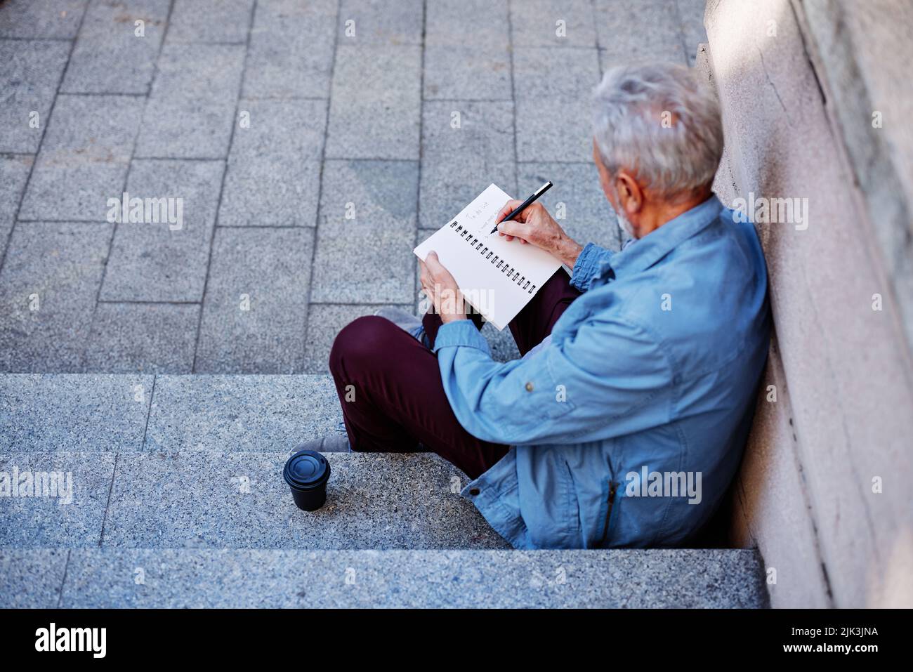 Top view of a senior man sitting outside and writing to do list Stock ...