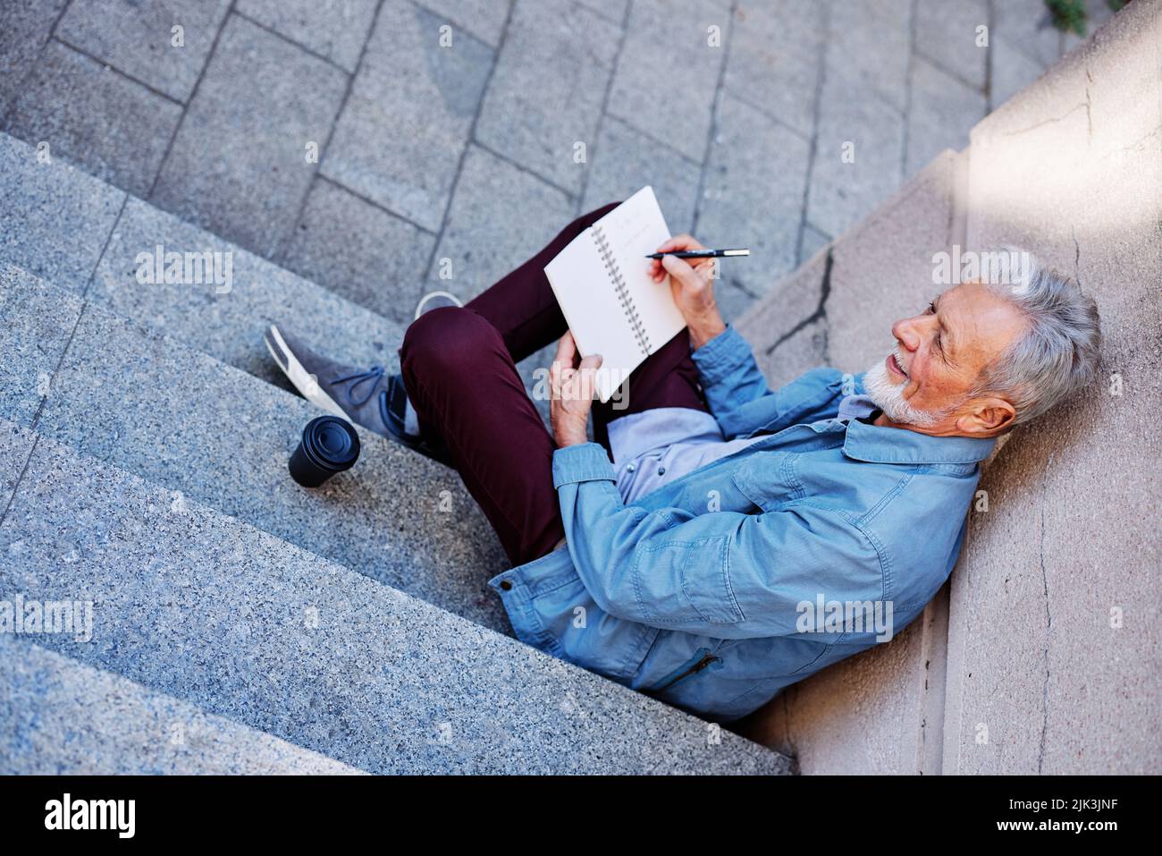 Top view of a senior man sitting outside and writing to do list Stock ...