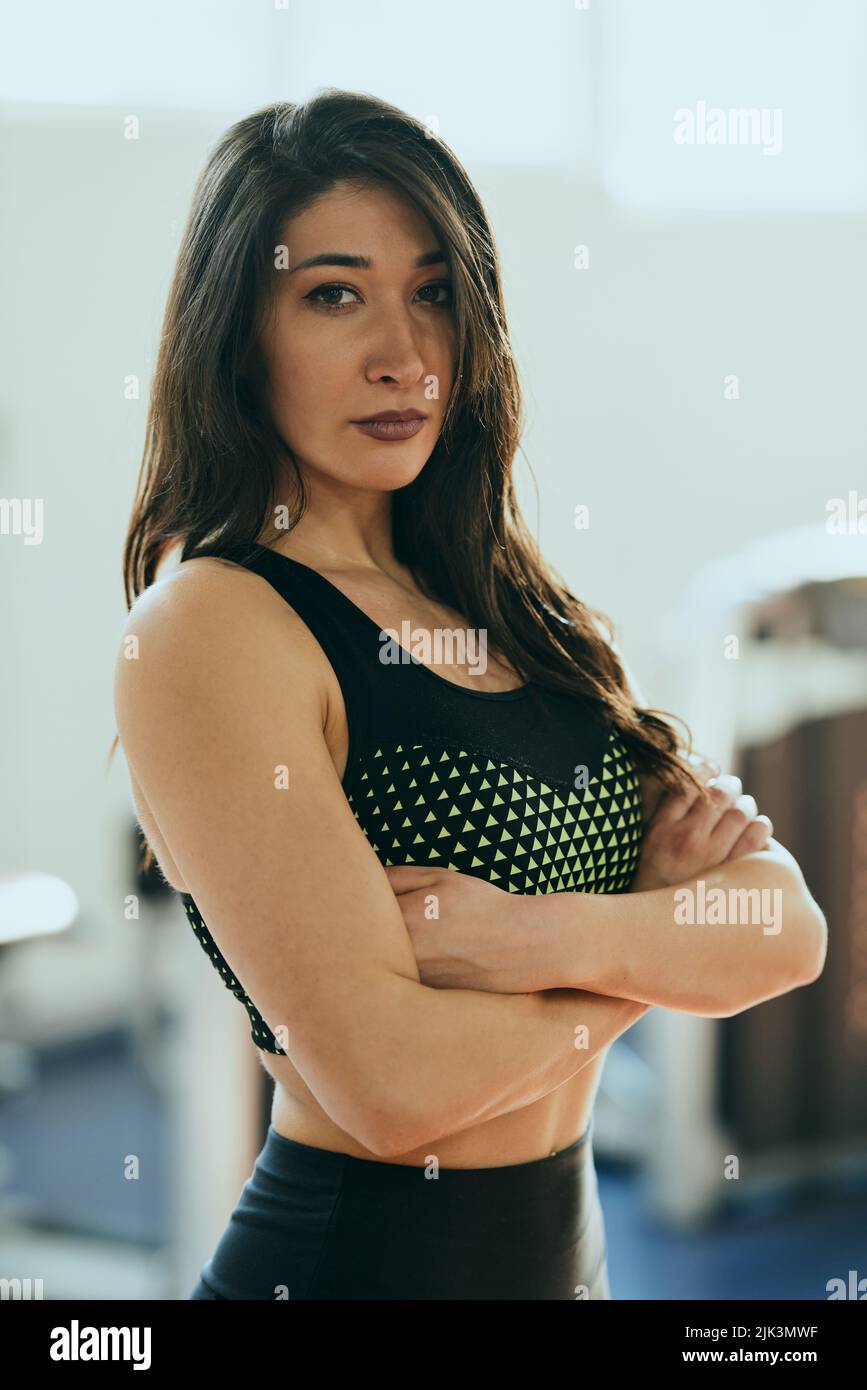 Portrait Of A Fit Muscular Sweaty Sportswoman Taking A Break In A Gym