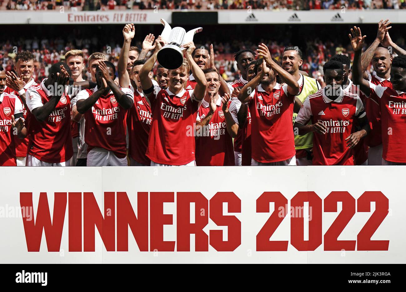 Arsenal captain Martin Odegaard lifts the trophy with team-mates after ...