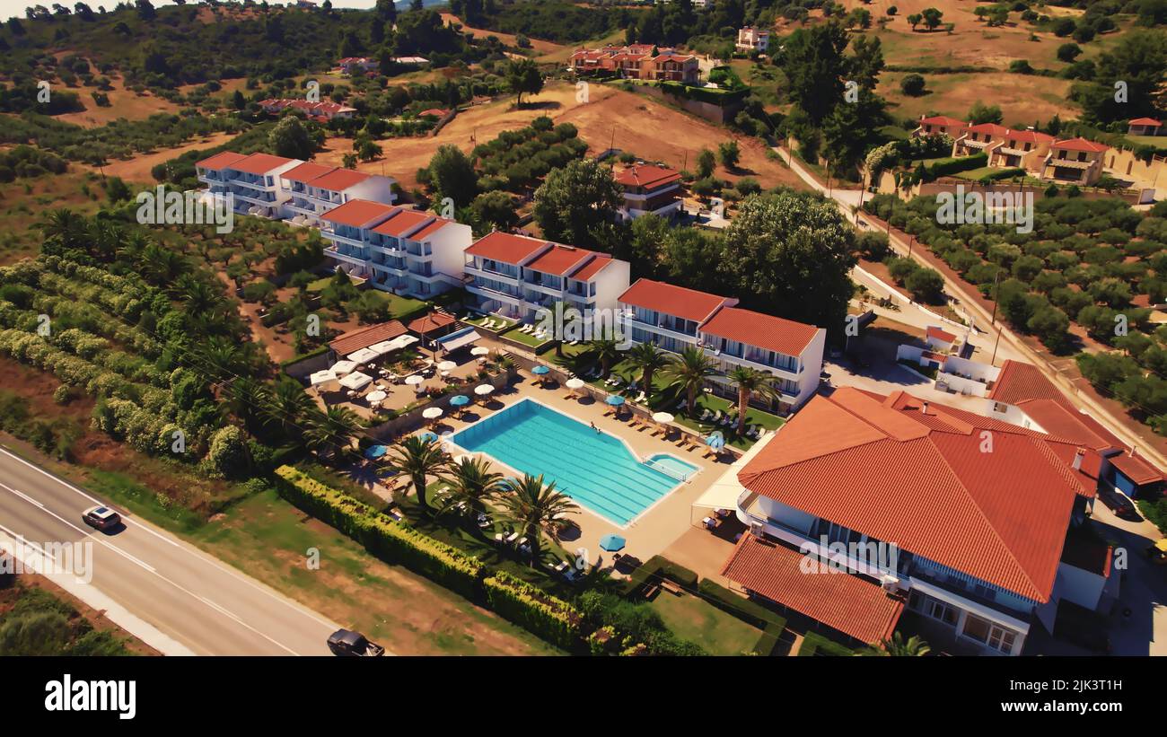 Aerial drone perspective of Greek luxurious hotel with small red-roofed ...