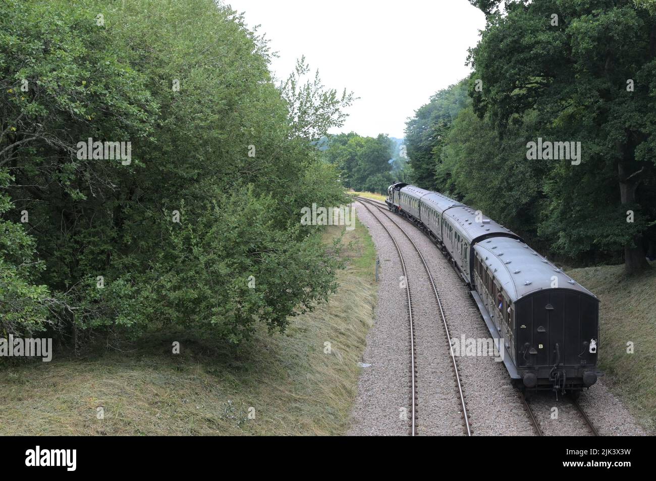 Passenger steam train disappearing into the distance Stock Photo - Alamy