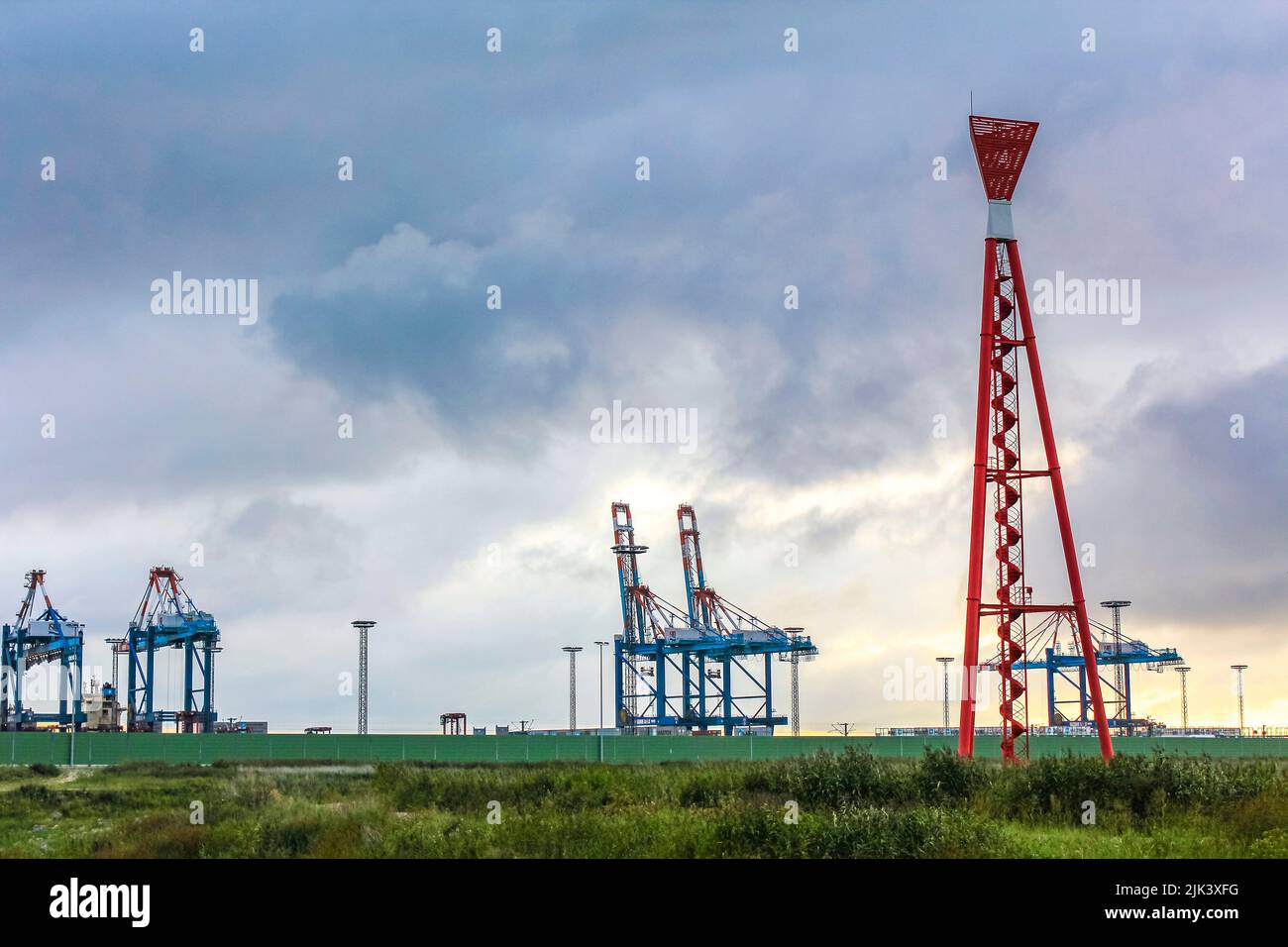Industrial area cranes and red tower lighthouse with beautiful ...