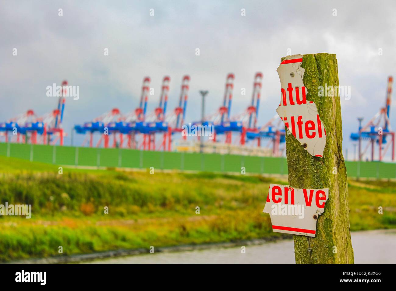 Industrial area cranes and red tower lighthouse with beautiful ...