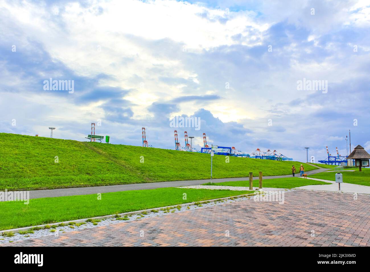 Industrial area cranes and red tower lighthouse with beautiful ...
