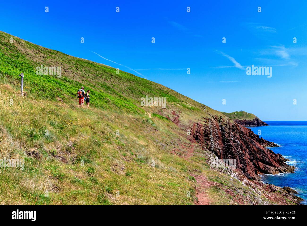 Walkers on the Pembrokeshire Coast Path in the National Park skirts ...