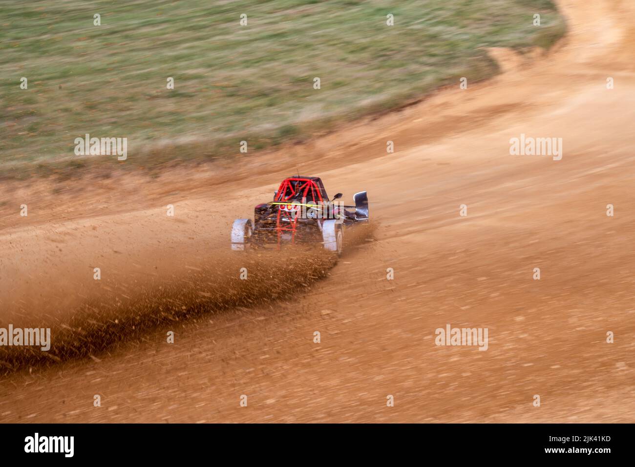 buggies on the autocross track, skidding, dust and dirt flying under ...